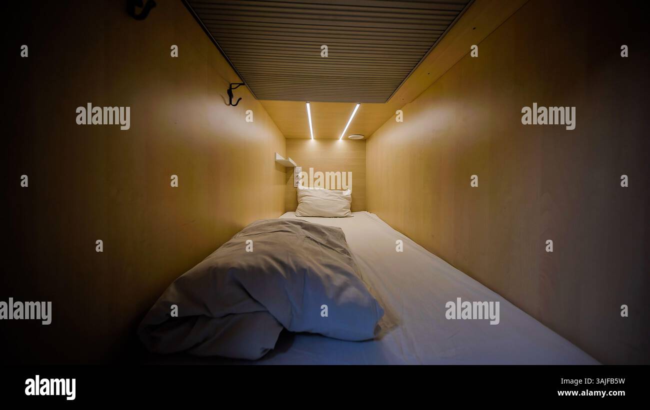 Capsule hotel room inviting guests for comfortable overnight stay Stock ...