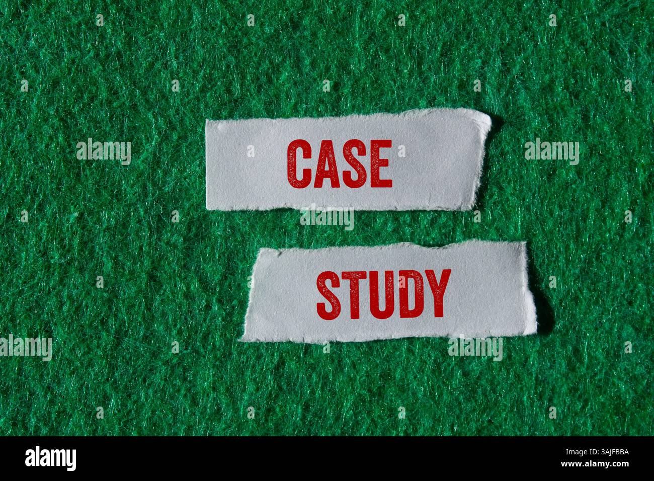 Case study message written on ripped torn paper pieces on green background. Conceptual case ...
