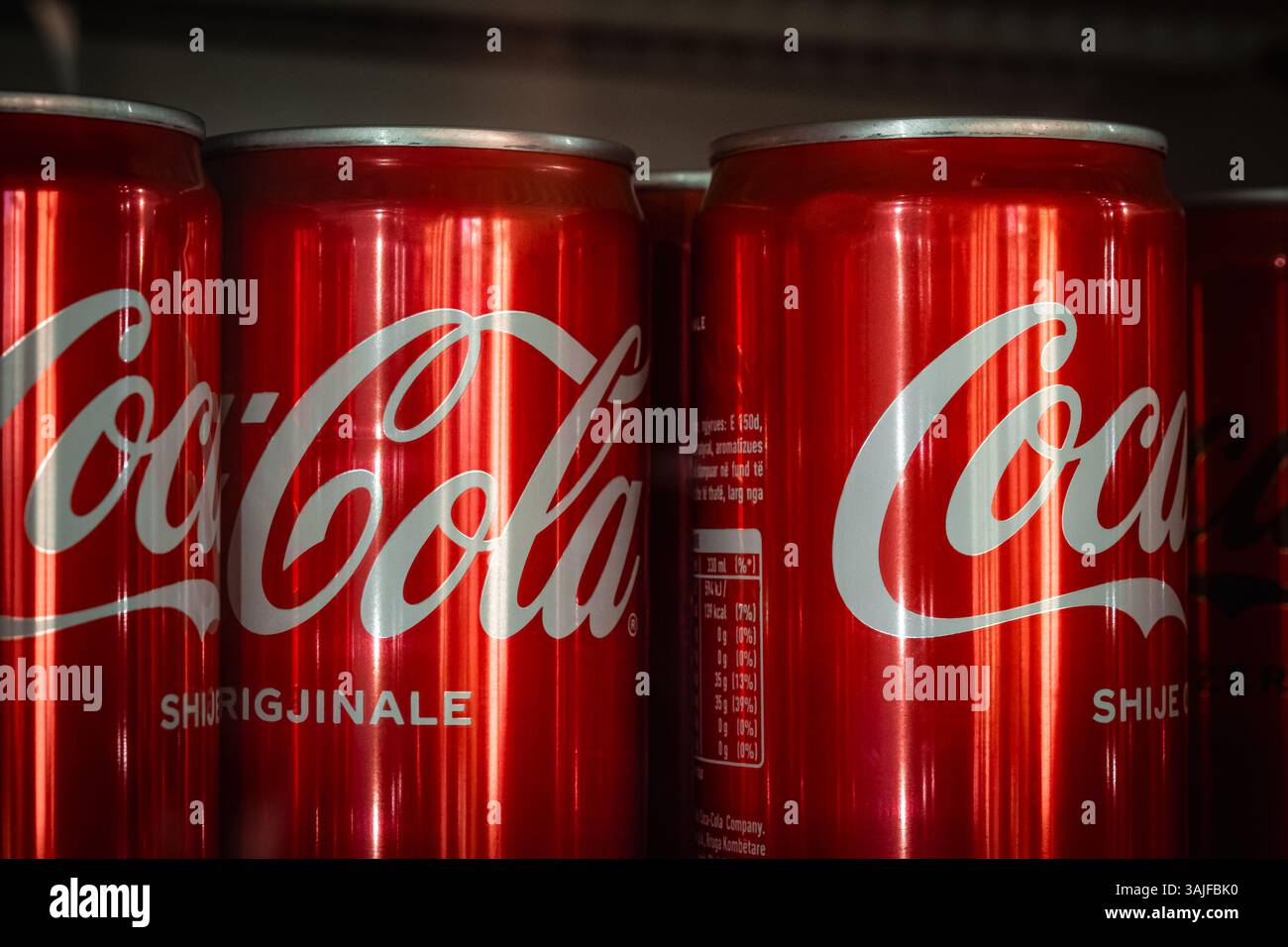 Coca-Cola brand soda cans in a commercial refrigerator, featuring Coke ...