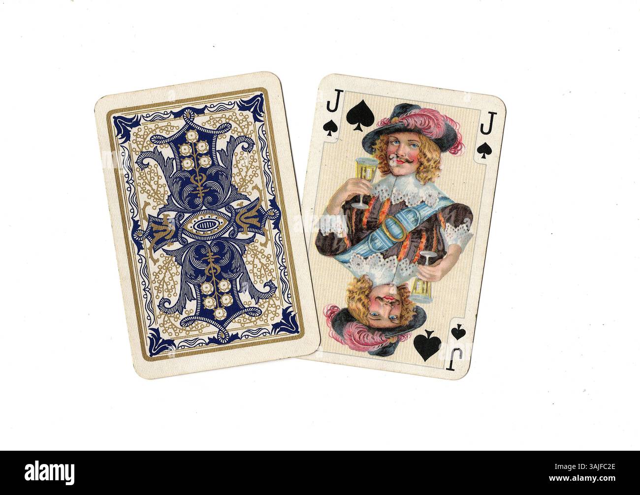 A pair of vintage playing cards with one card revealed in the suit of ...