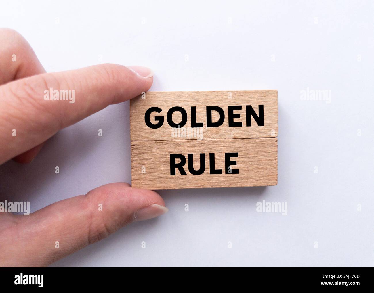 Golden rule message written on wooden blocks on white background ...