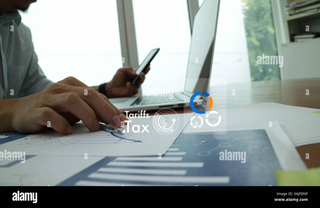 Person working on documents and a laptop with digital overlays showing ...