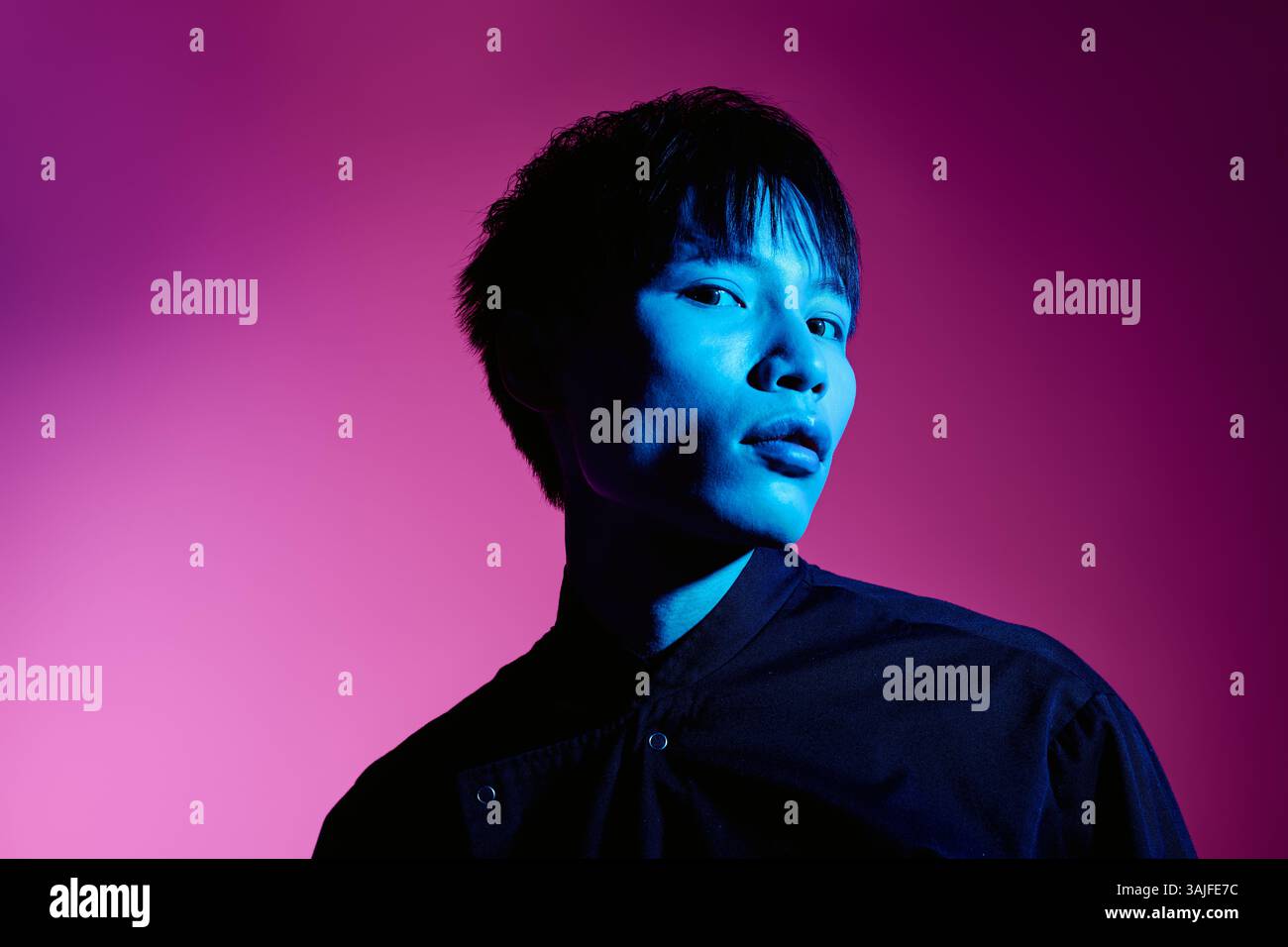 Stylish Asian man exudes charisma in bold colors with a striking ...