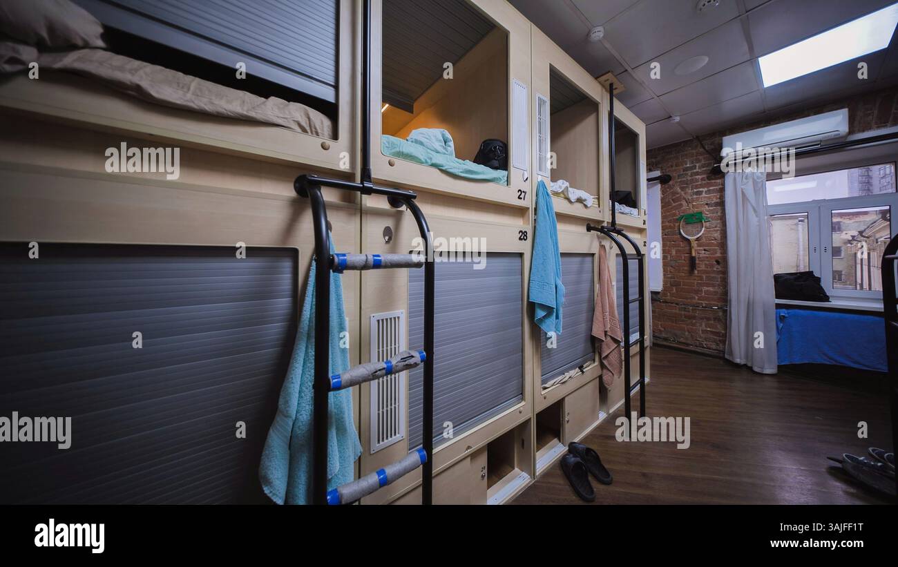 Capsule hotel room showing individual sleeping boxes offering privacy and convenience Stock ...