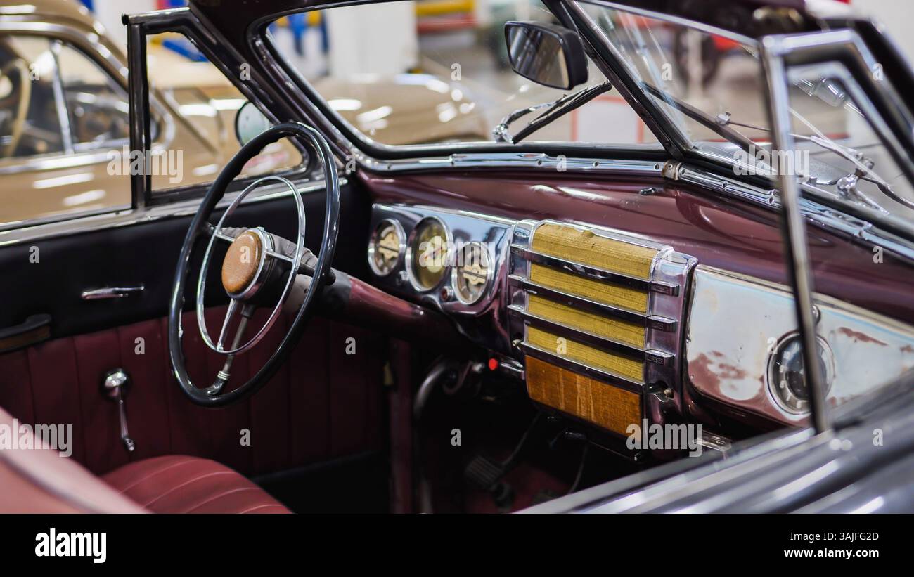 Interior view of vintage convertible car showing steering wheel and ...