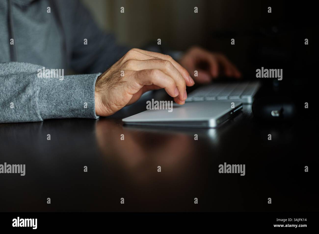 Desk and hands of a young programmer Stock Photo - Alamy