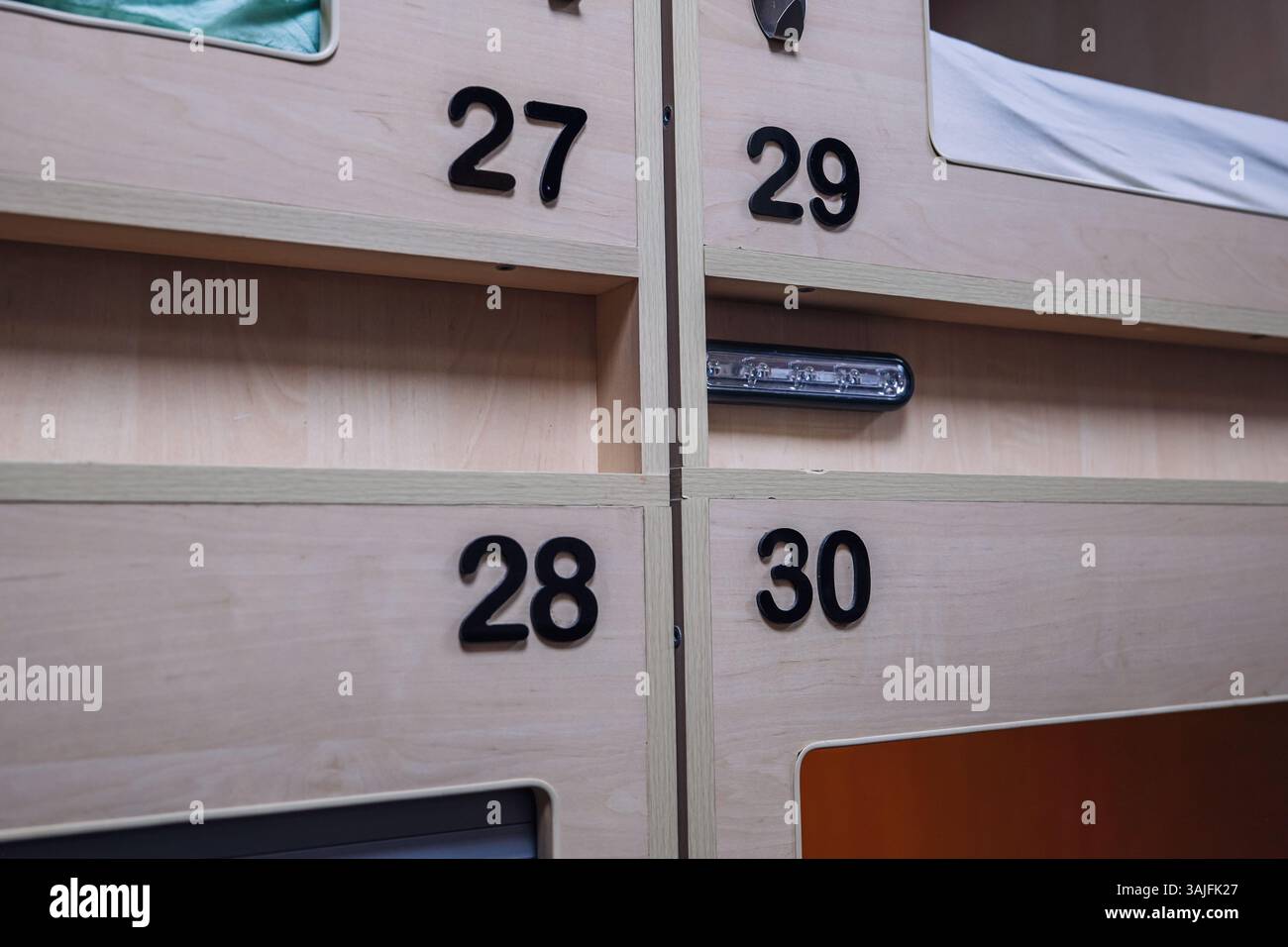Numbered capsule hotel rooms offering privacy and comfort Stock Photo ...