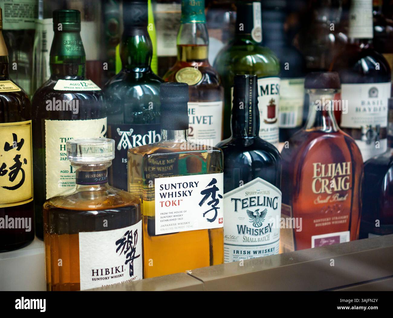 A collection of domestic and imported liquor on display in the window ...