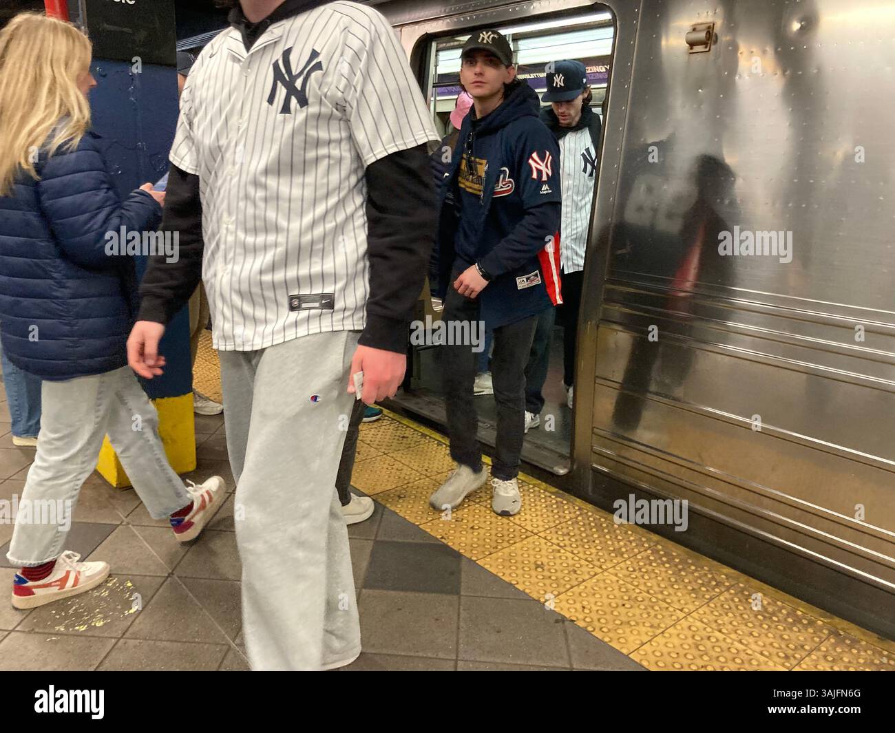 Yankee fans depart a crowded New York subway train on Wednesday, April ...