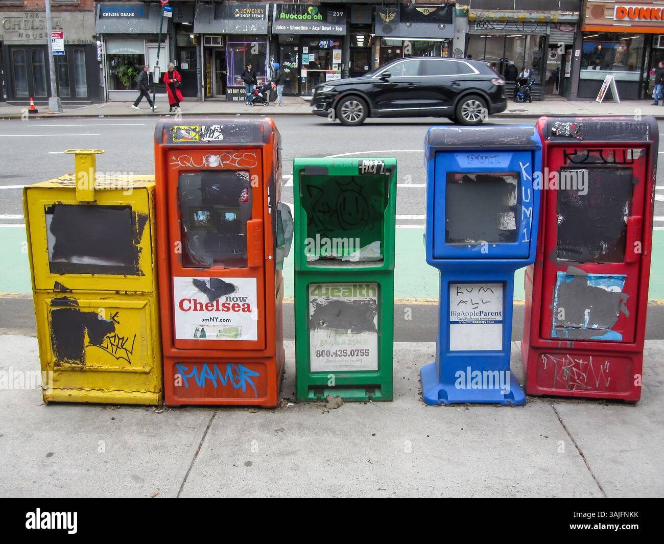 A collection of disused and distressed newspaper boxes lined up in a ...