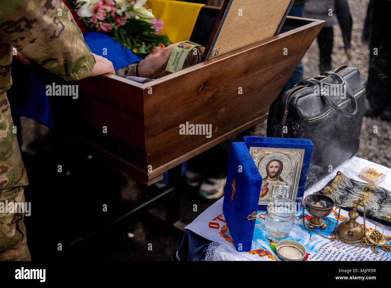 An icon of Jesus Christ lies in front of the coffin of Marharyta ...
