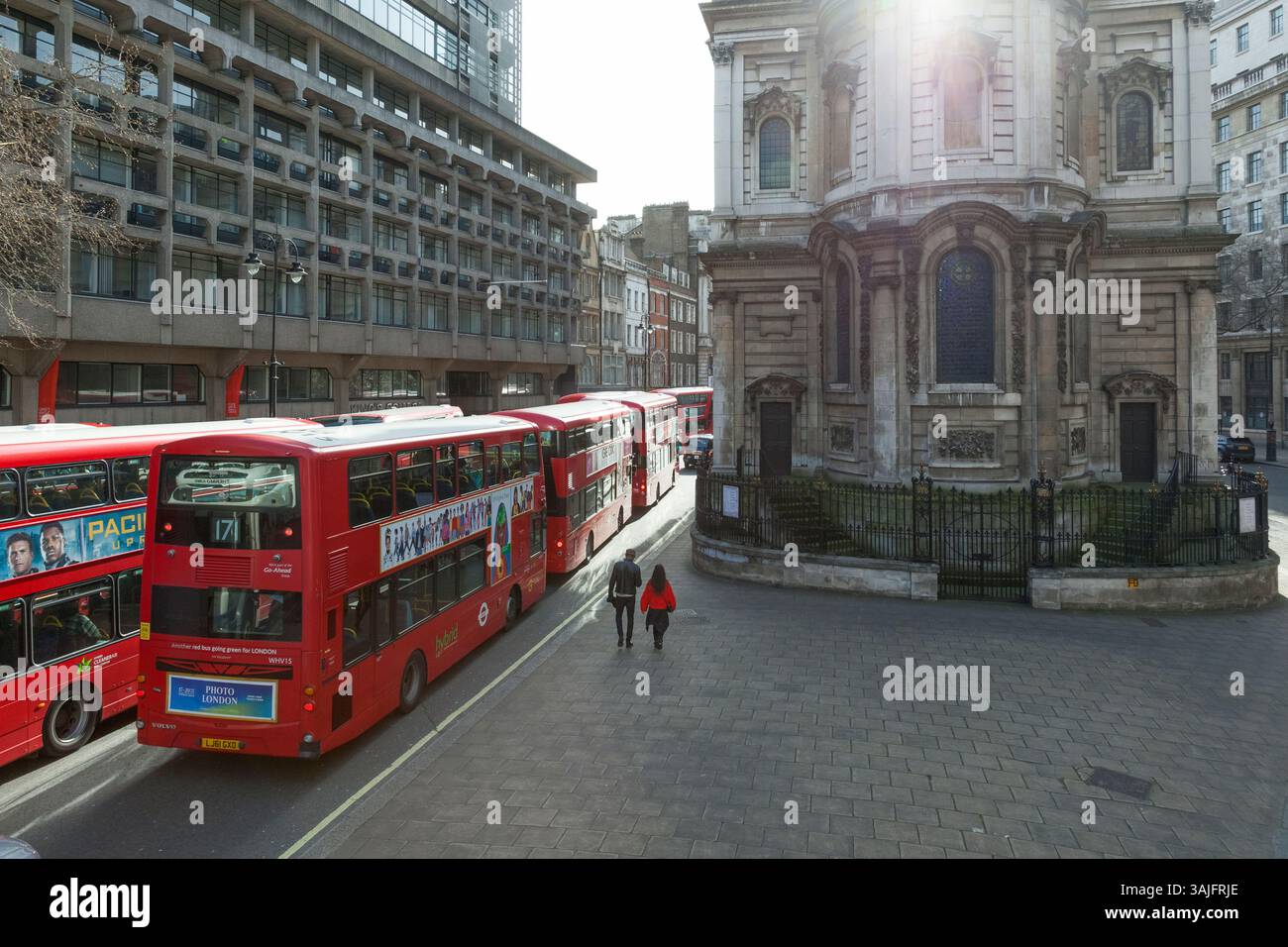 A queue of London double-decker buses congesting the street at Aldwych ...