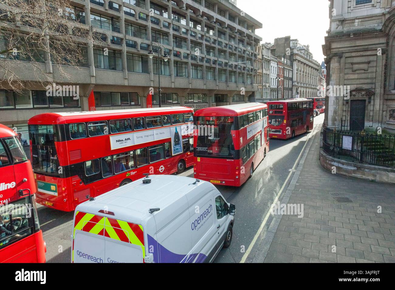 A queue of London double-decker buses congesting the street at Aldwych ...