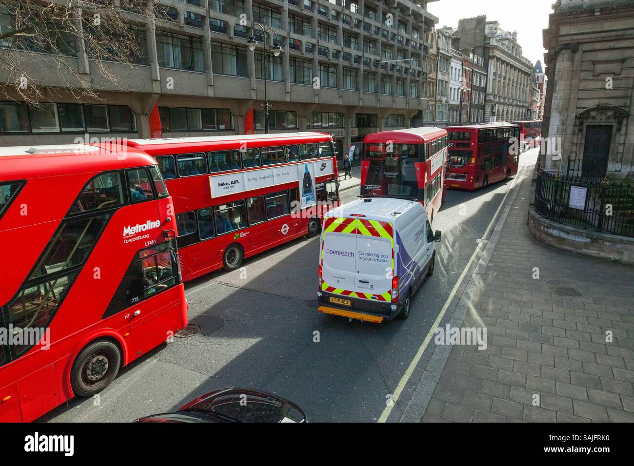 A queue of London double-decker buses congesting the street at Aldwych ...