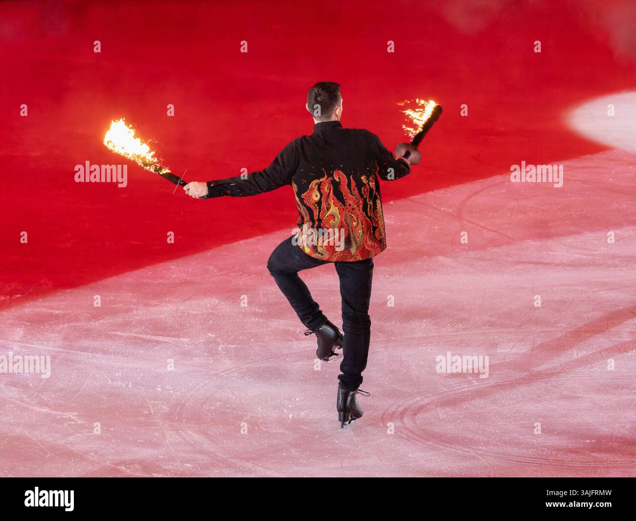 Skater Performing an Artistic Performance on the Ice Rink with Flaming ...