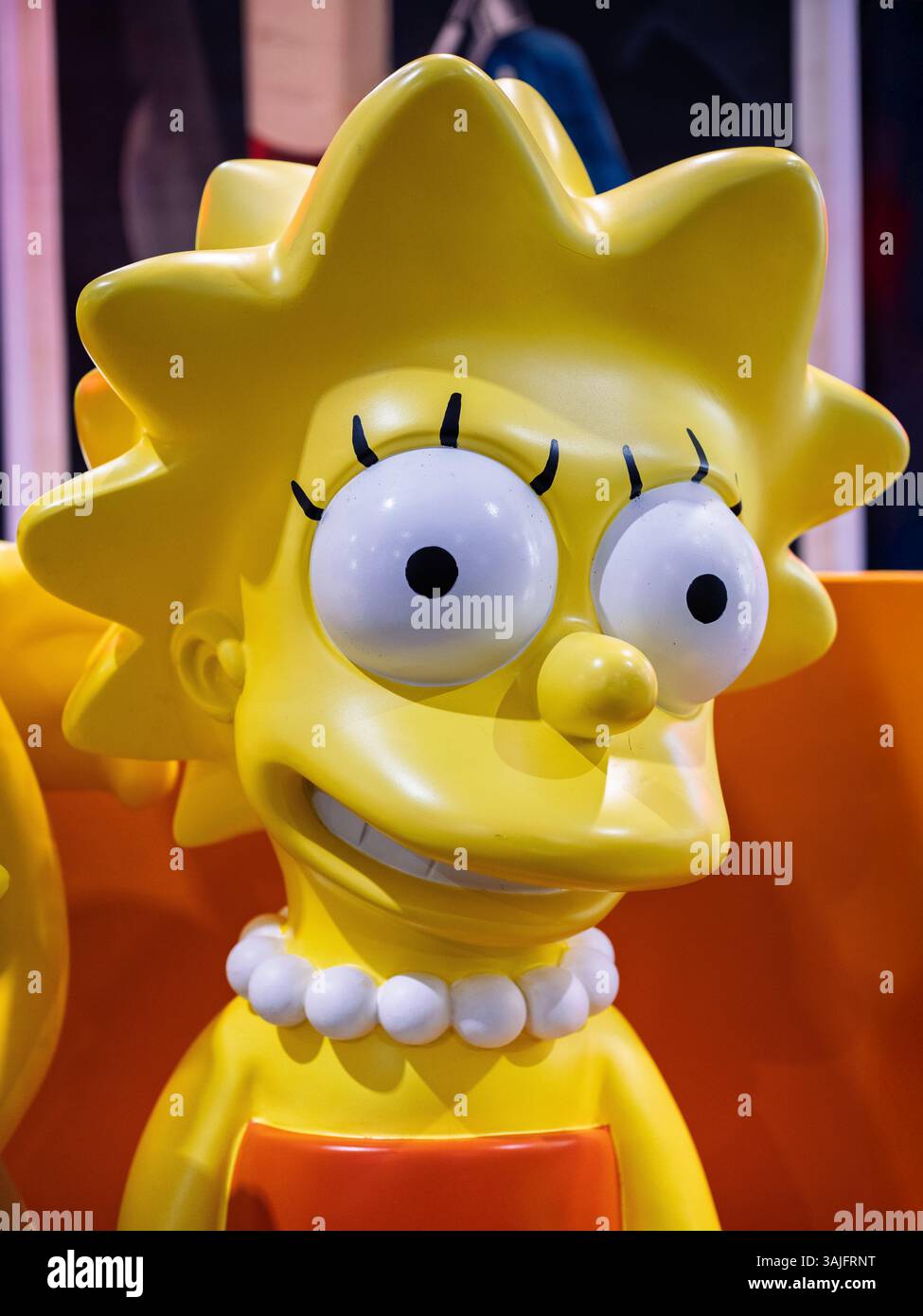Close-up of Yellow cartoon character Lisa Simpson Statue with pearl ...