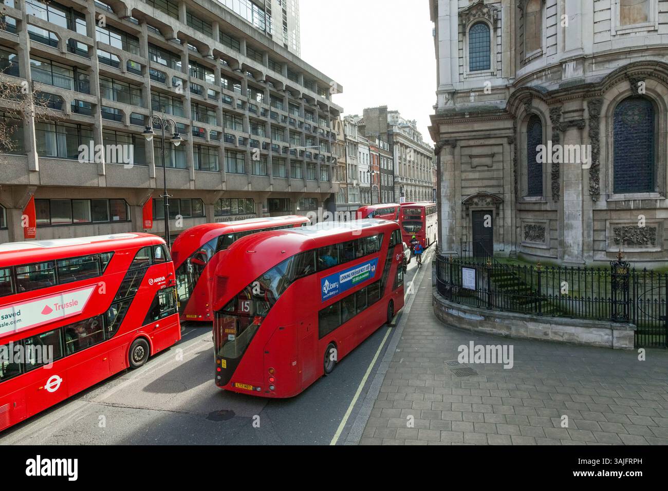 A queue of London double-decker buses congesting the street at Aldwych ...