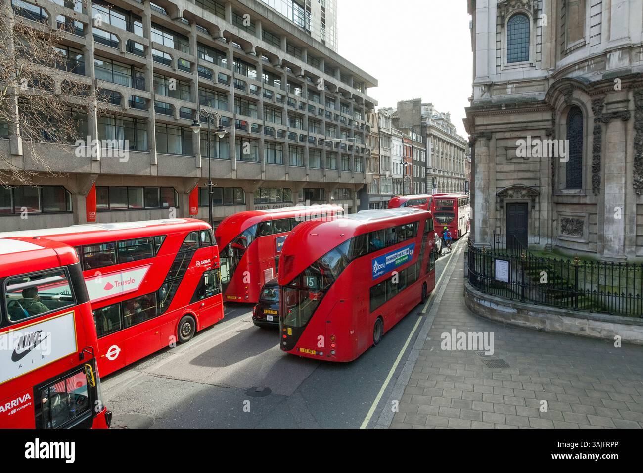 A queue of London double-decker buses congesting the street at Aldwych ...