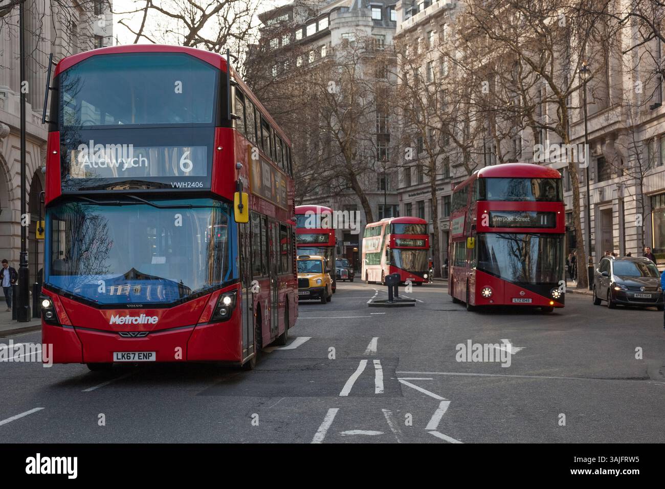 A queue of London double-decker buses congesting the street at Aldwych ...