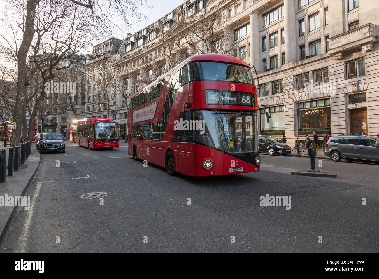 A queue of London double-decker buses congesting the street at Aldwych ...