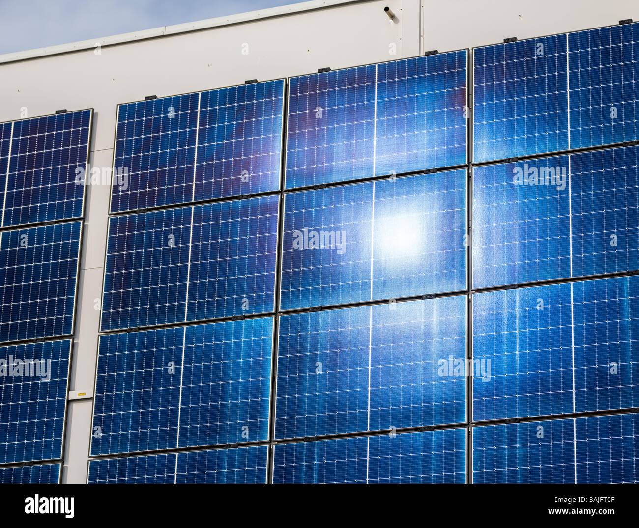 large solar panel array on industrial building facade Stock Photo - Alamy