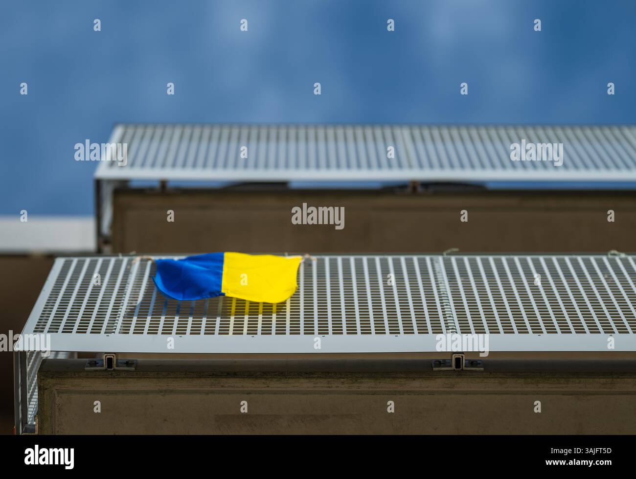 Small flag displayed on metal balcony railing Stock Photo - Alamy