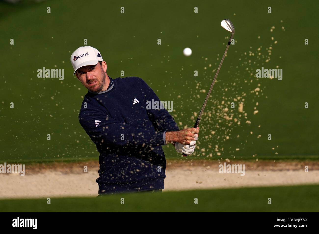 Nick Taylor, of Canada, hits from the bunker on the second hole during ...