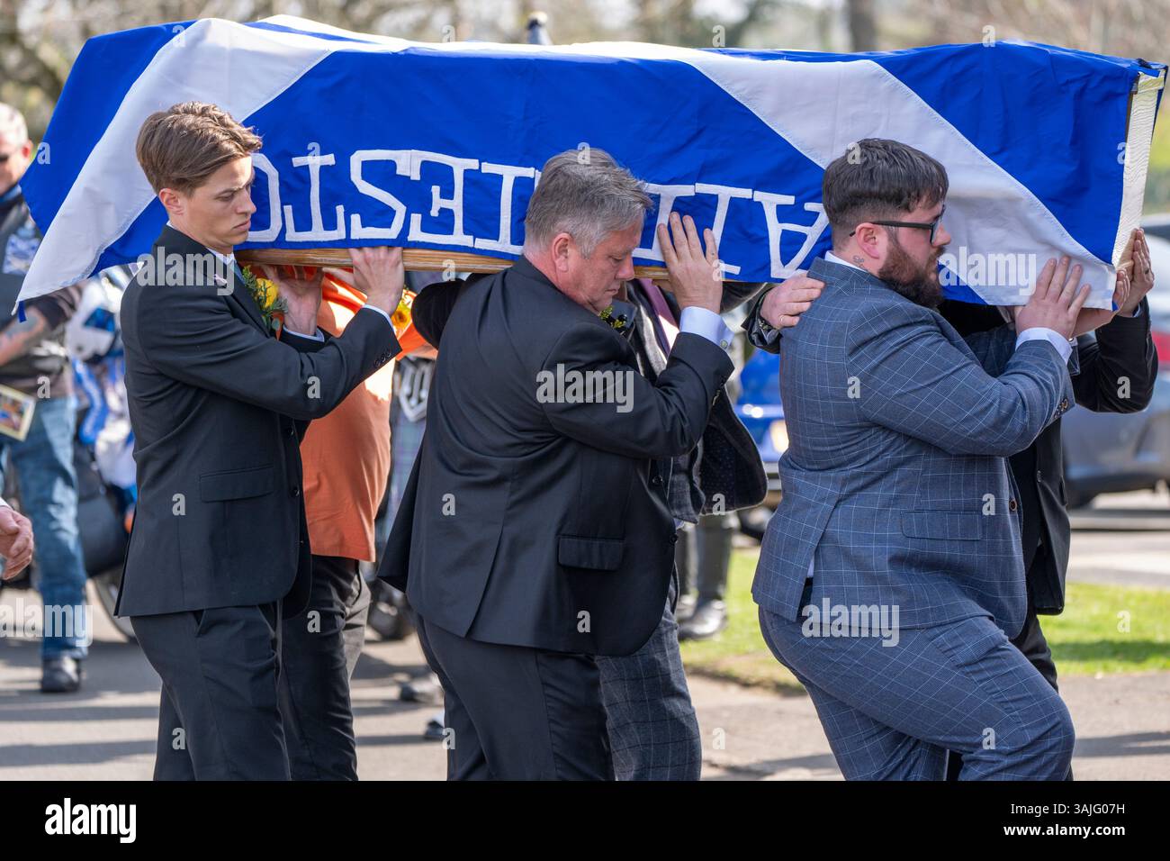 Keith Brown MSP (centre) carries the coffin at the funeral of his ...