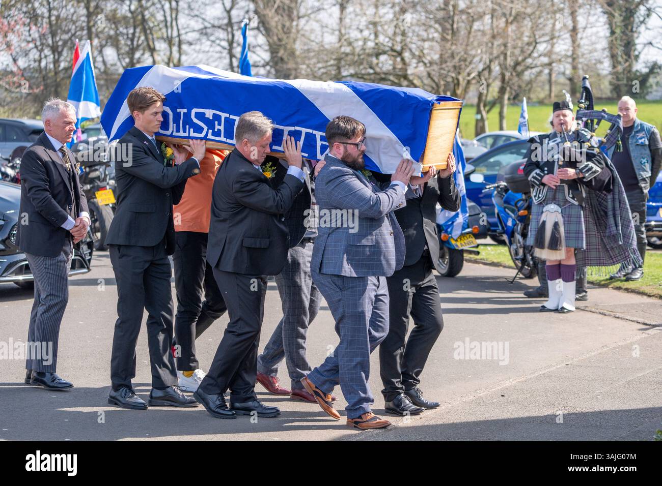 Keith Brown MSP (centre) carries the coffin at the funeral of his ...
