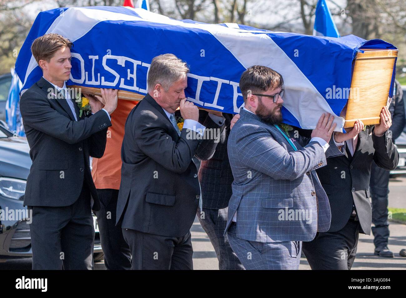 Keith Brown MSP (centre) carries the coffin at the funeral of his ...