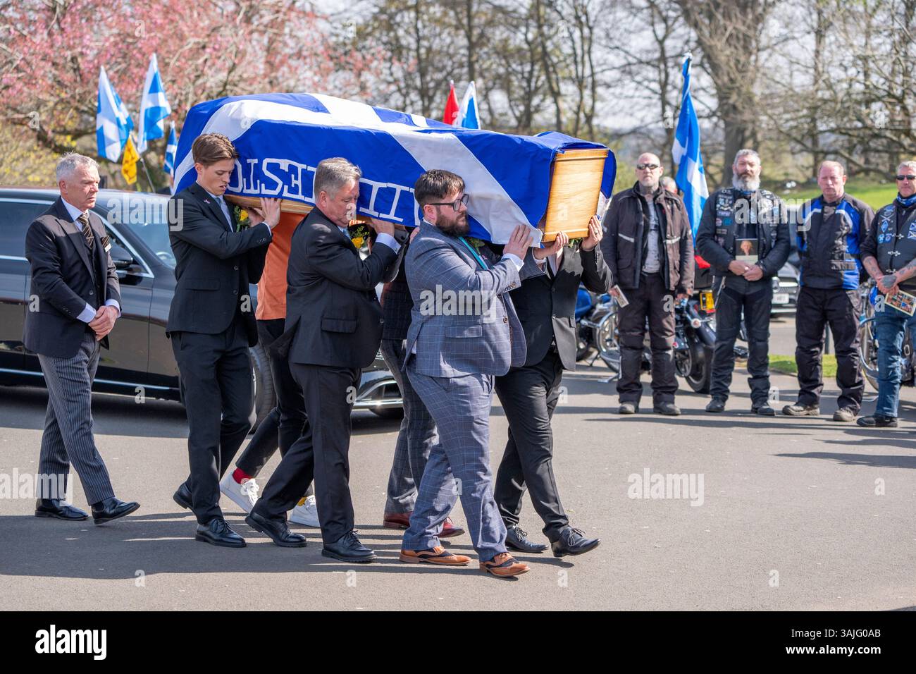 Keith Brown MSP (centre) carries the coffin at the funeral of his ...