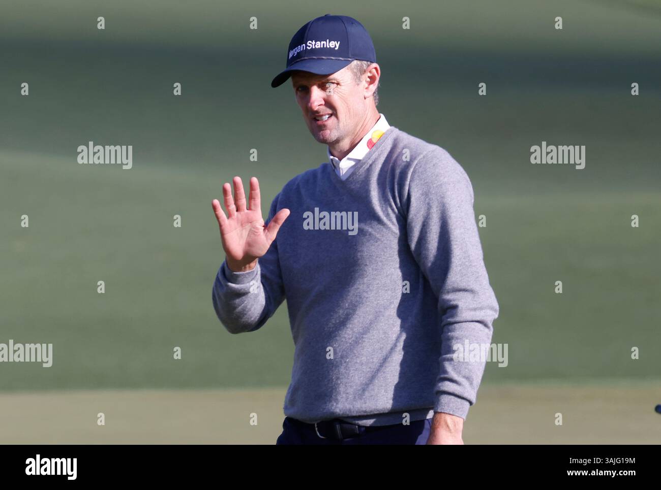 Justin Rose of England walks onto the green on the second hole during ...