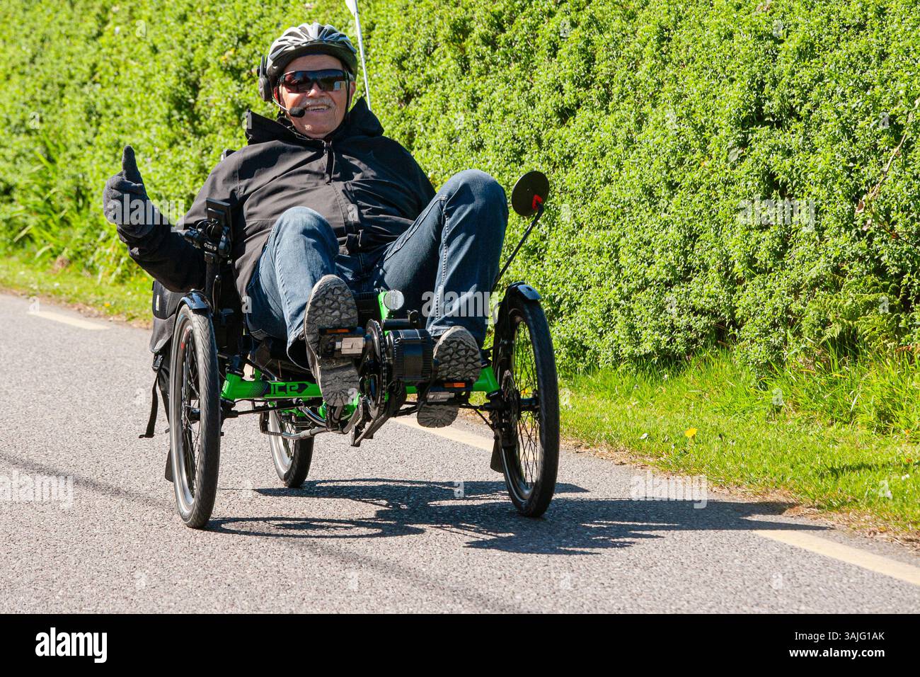 Senior man riding recumbent trike in County Kerry, Ireland Stock Photo ...