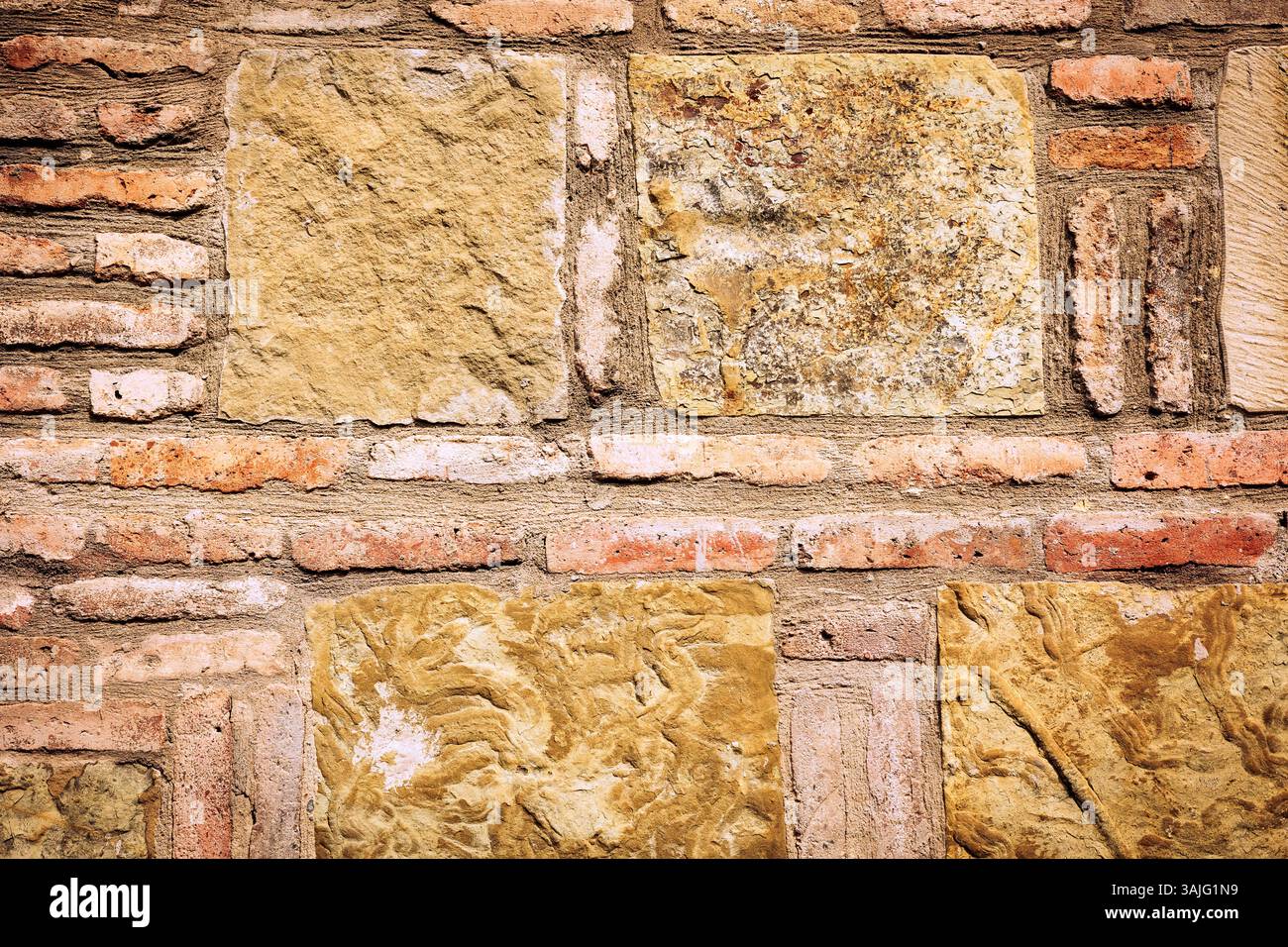 Close-up of a rustic stone and brick wall with irregular patterns and ...