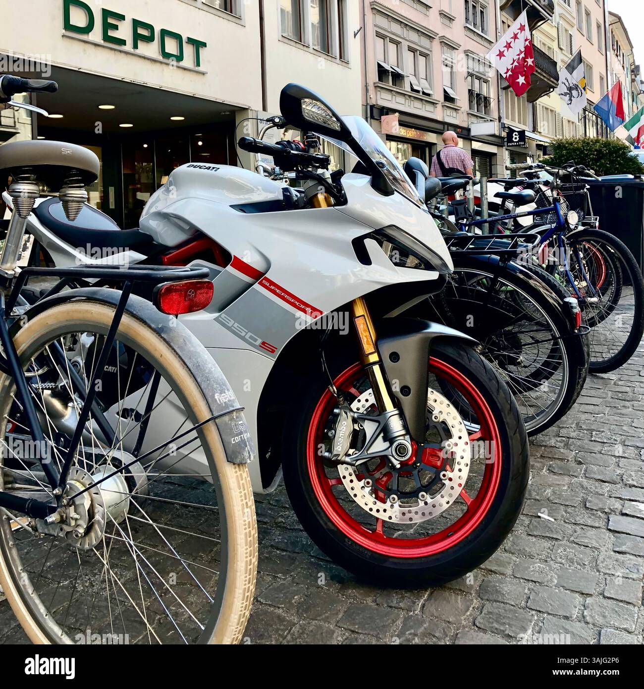 Motorcycle in between bicycles Stock Photo - Alamy