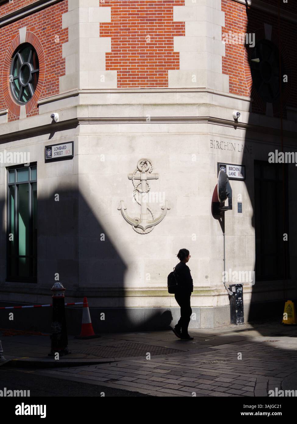 Pedestrians walk past Anchor sign at junction of Birchin Lane and ...