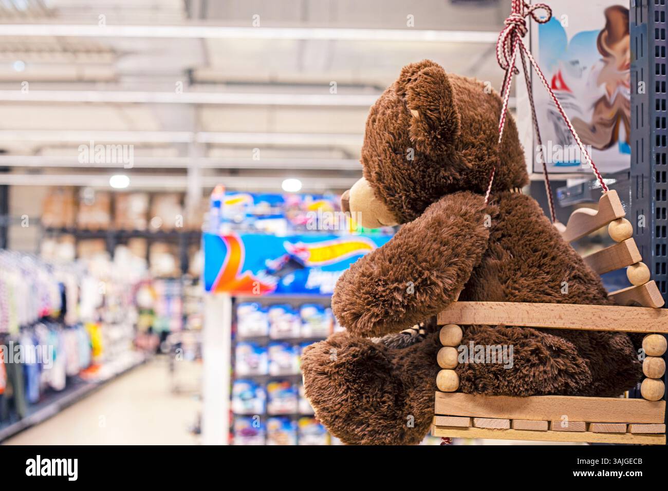 cute brown teddy bear in the toy department of the supermarket Stock ...