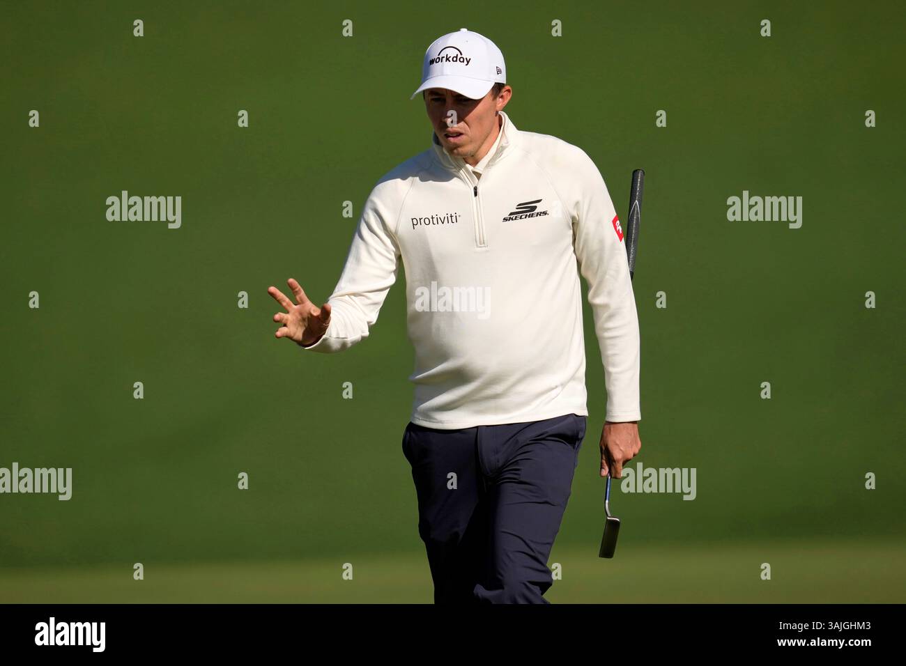 Matt Fitzpatrick, of England, waves after making a putt on the second ...