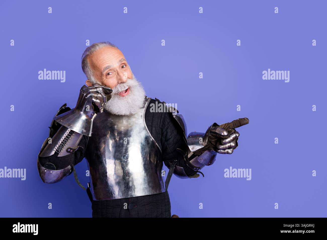 Elderly man in medieval knight costume laughing and gesturing against ...