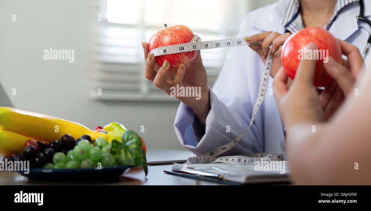 Nutrition and Wellness. A nutritionist measuring apples to explain ...