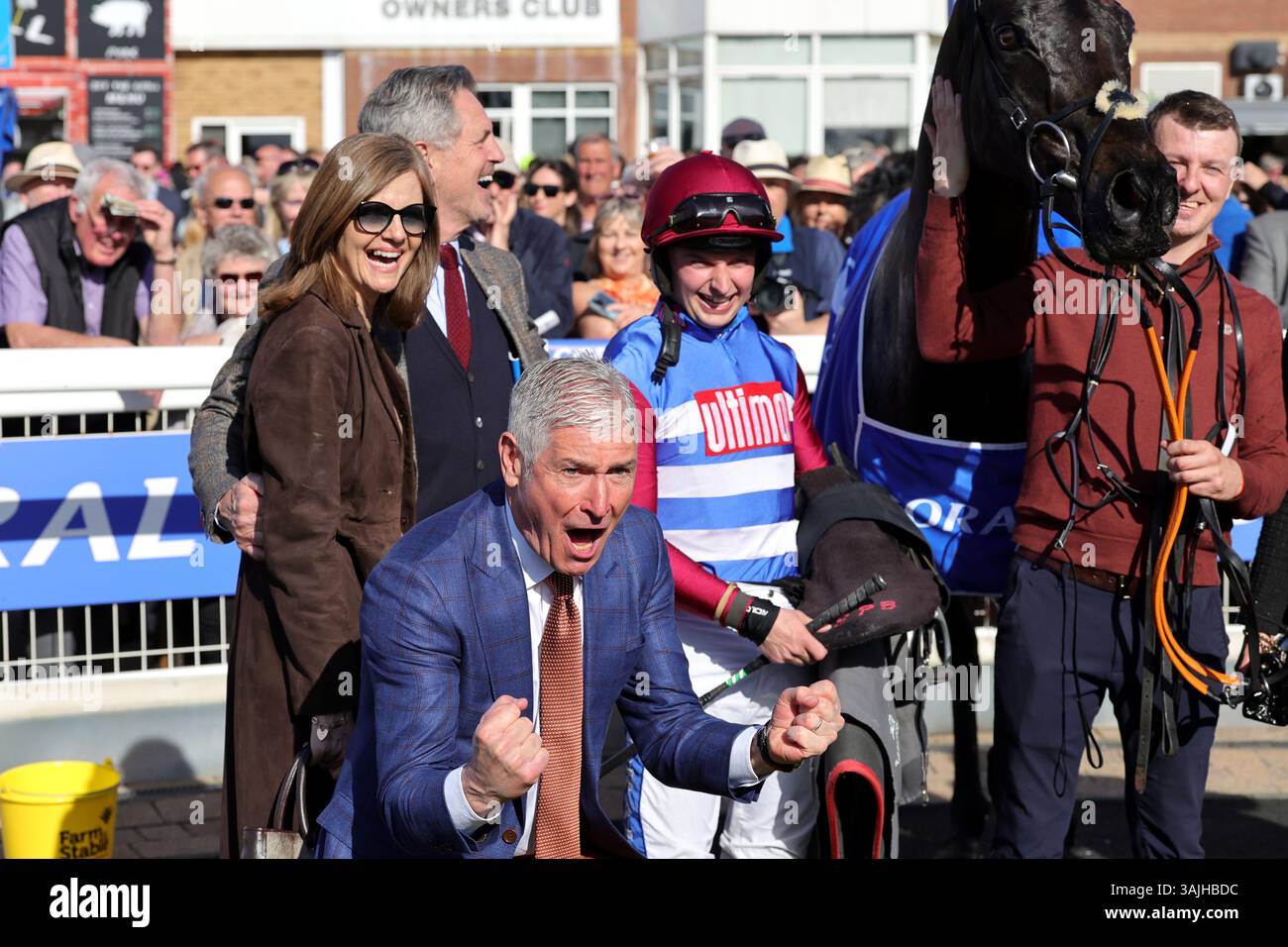 Jockey Sean Bowen (centre) smiles as owner of horse The Four Sixes, Max ...