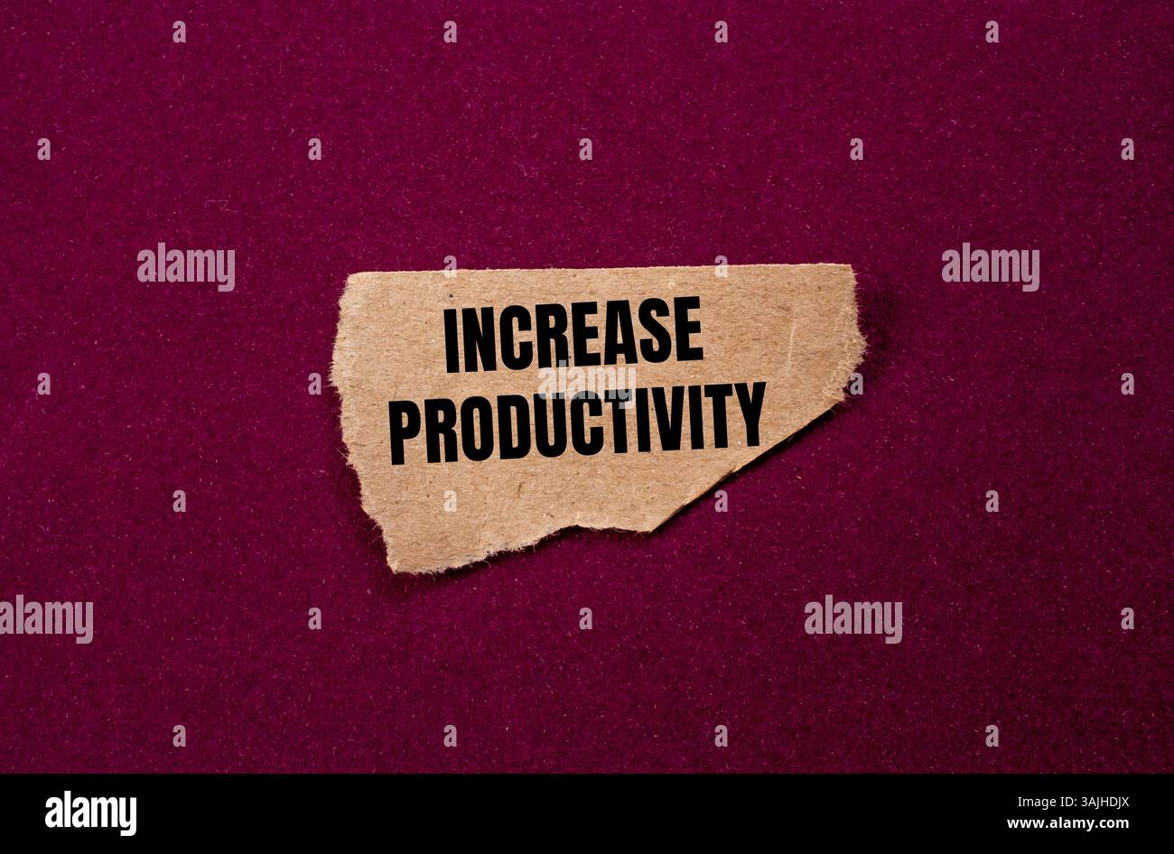 Increase productivity message written on ripped torn brown paper piece on purple background ...