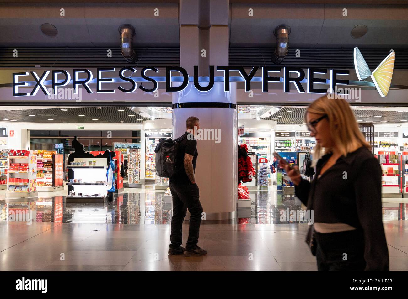Madrid, Spain. 15th Aug, 2024. Flight passengers walk past a duty-free ...