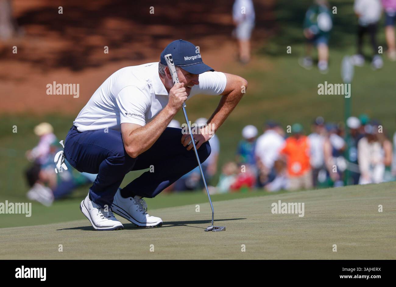 Justin Rose of England lines up a putt on the ninth hole during round ...