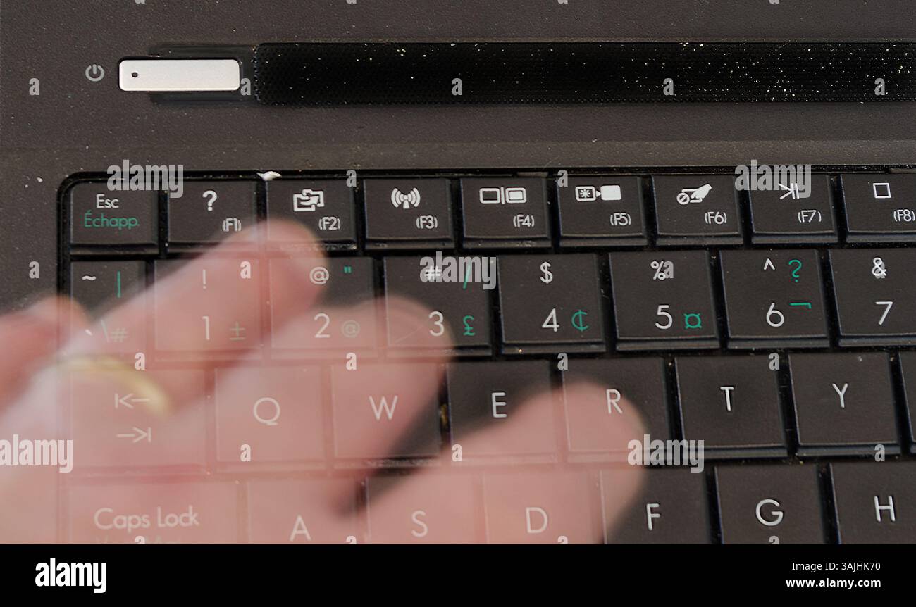 Ghost hand touching computer keyboard Stock Photo - Alamy