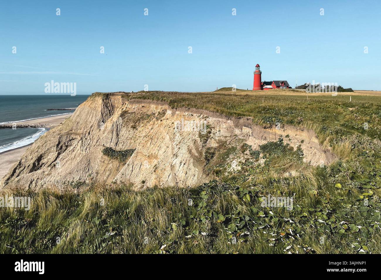 The cliffs of Lemvig, Denmark. With the Bovbjerg Lighthouse Stock Photo ...