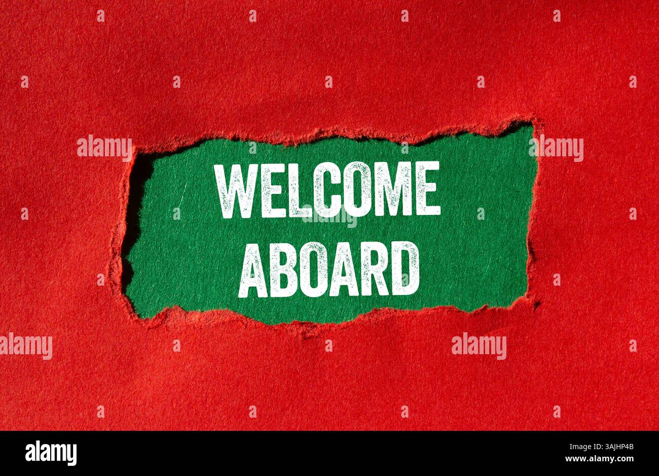 Welcome aboard message written on ripped torn red paper on green background. Conceptual welcome ...