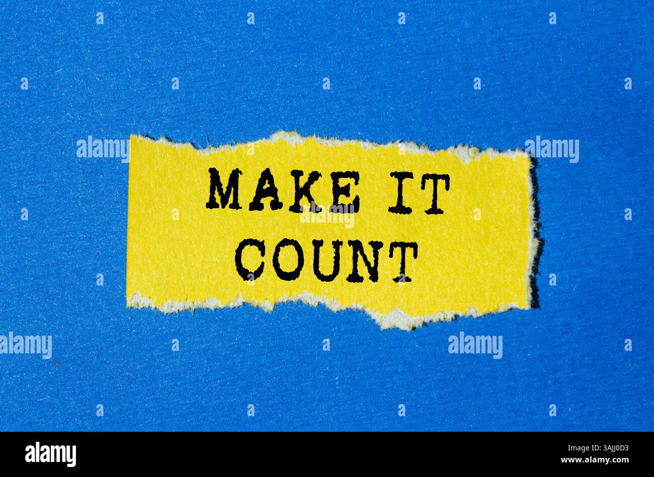 Make it count message written on ripped torn yellow paper on blue ...