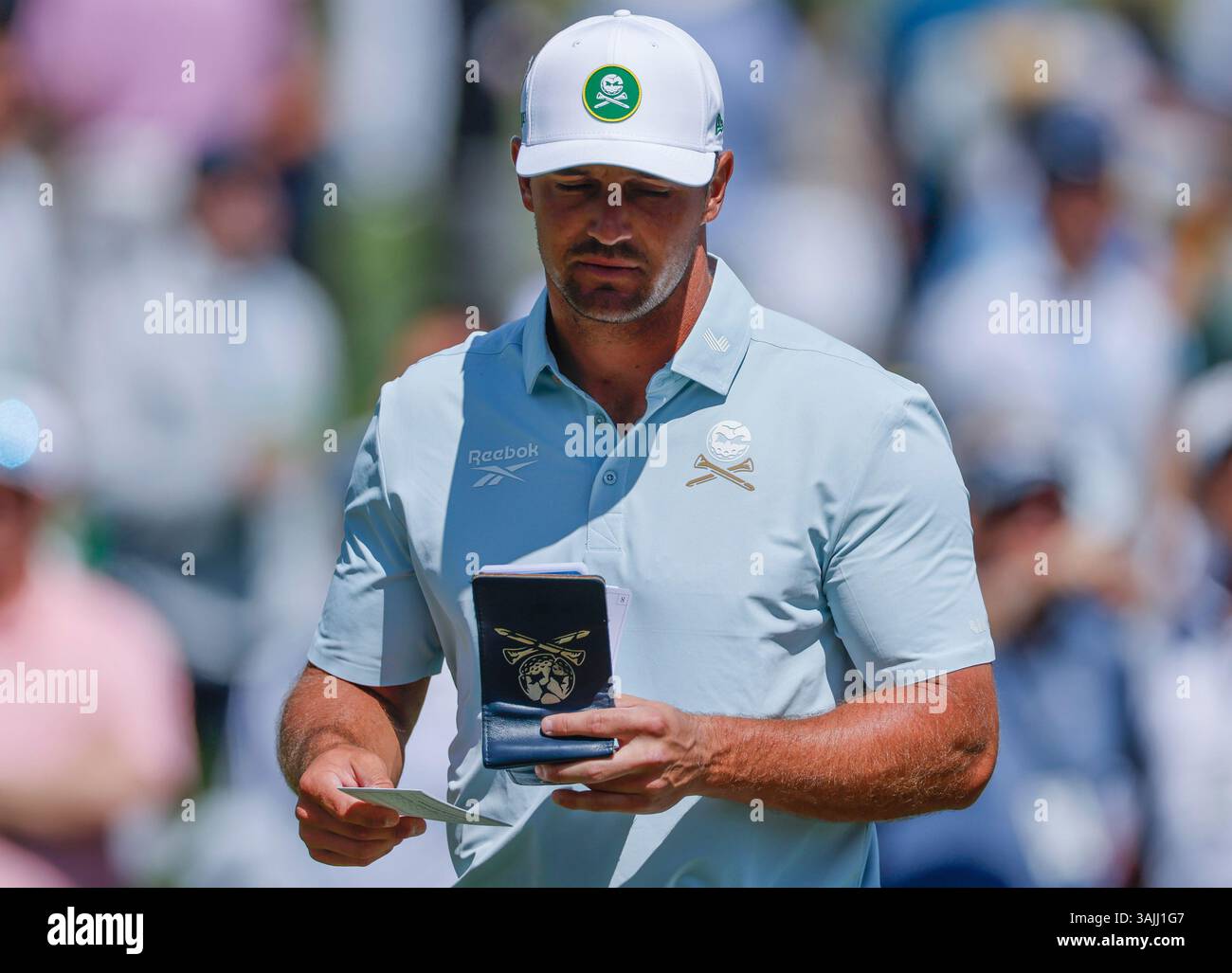 Augusta, United States. 11th Apr, 2025. Bryson DeCambeau checks his ...