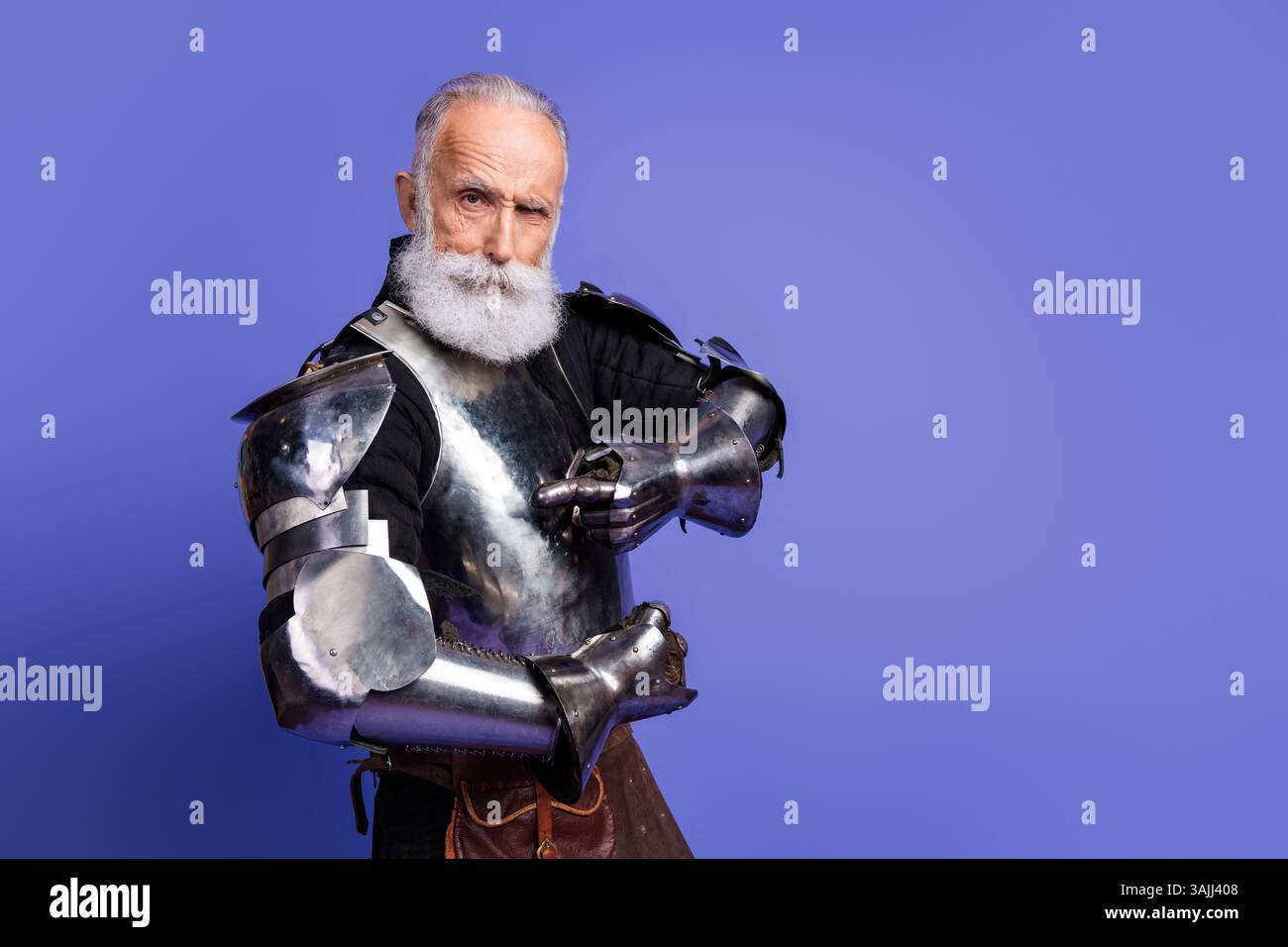 Senior man in medieval armor posing confidently against a vibrant ...